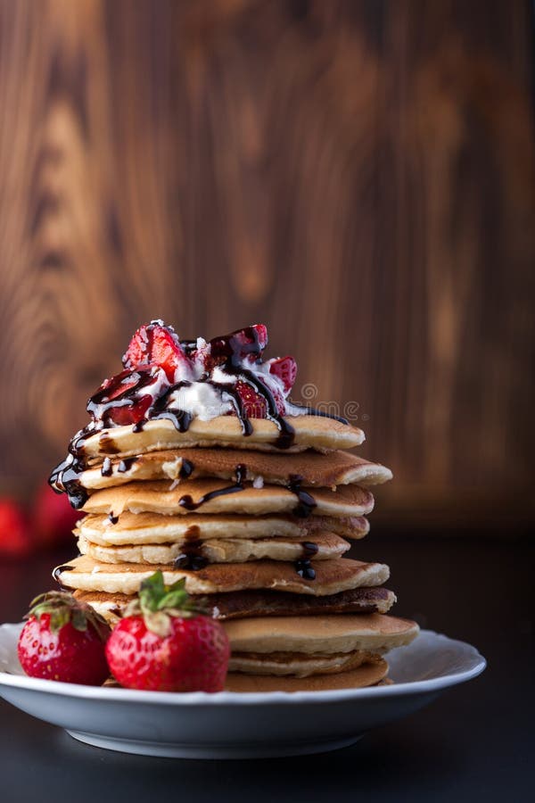 Stack of Pancakes with Strawberries, Whip Cream and Chocolate Syrup on ...