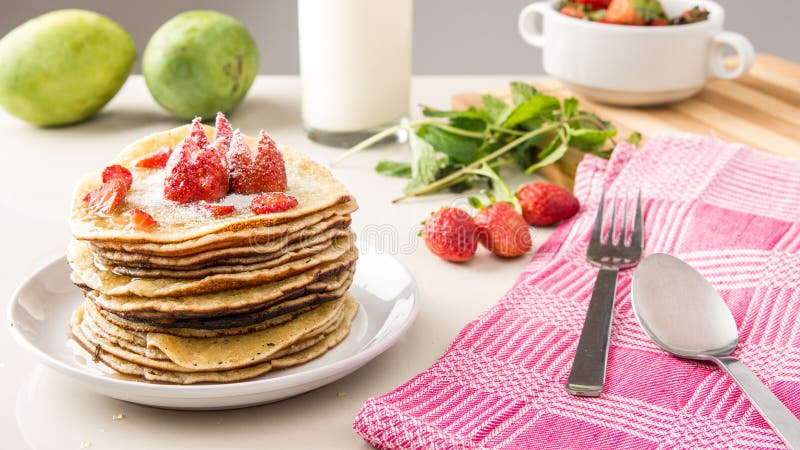 Stack of Pancakes on Table with Strawberries, Mint, Honey and Sugar ...