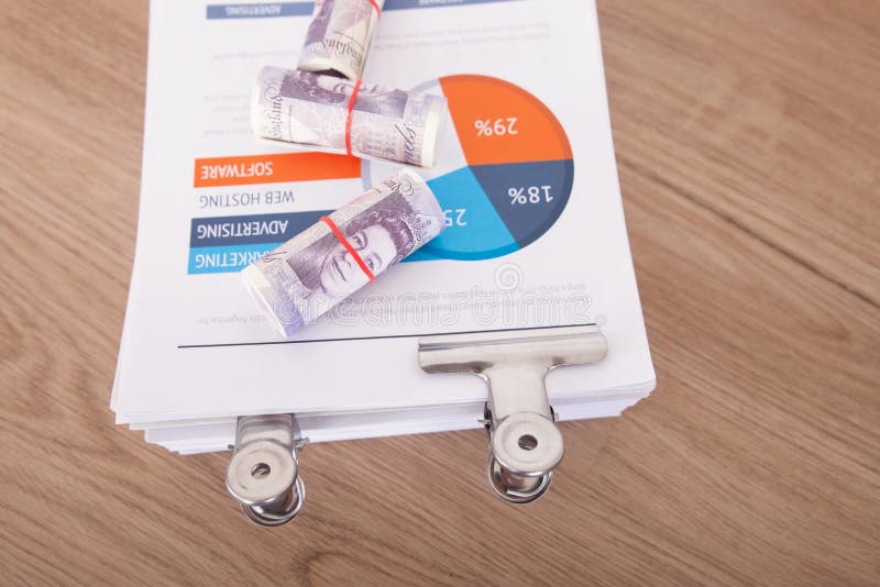 Stack of Paper Business Documents and Several Rolls of British Pound ...