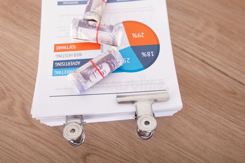 Stack of Paper Business Documents and Several Rolls of British Pound ...