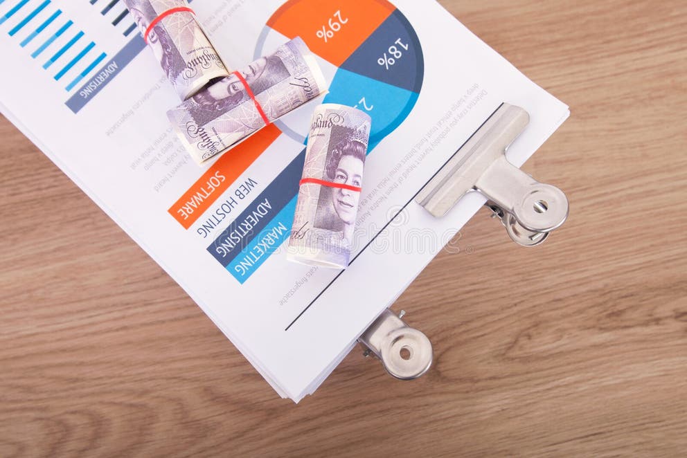 Stack of Paper Business Documents and Several Rolls of British Pound ...