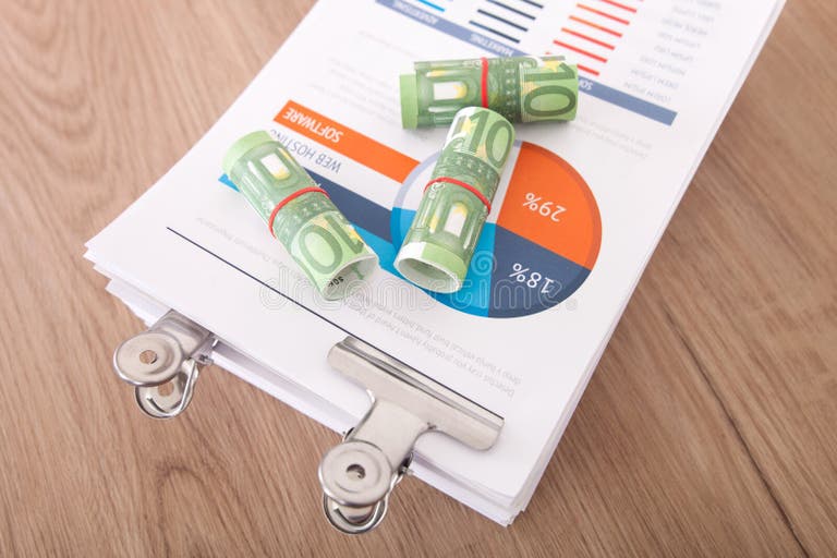 A Stack of Paper Business Documents and Several Rolls of Euro Banknotes ...