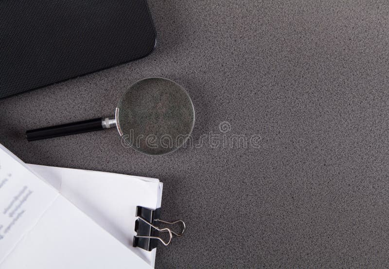 Stack of Paper Documents with Magnifying Glass and Computer, on Table ...
