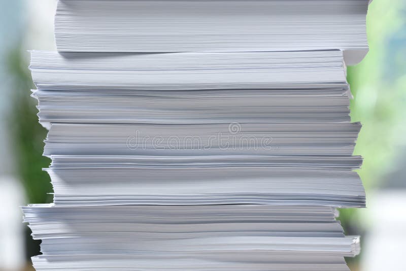 Stack of Paper Sheets Against Blurred Background, Closeup Stock Image ...