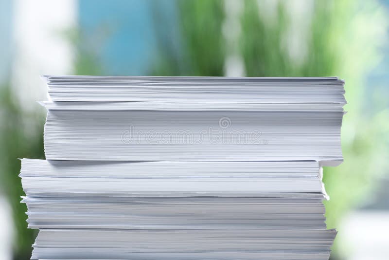 Stack of Paper Sheets Against Blurred Background, Closeup Stock Photo ...