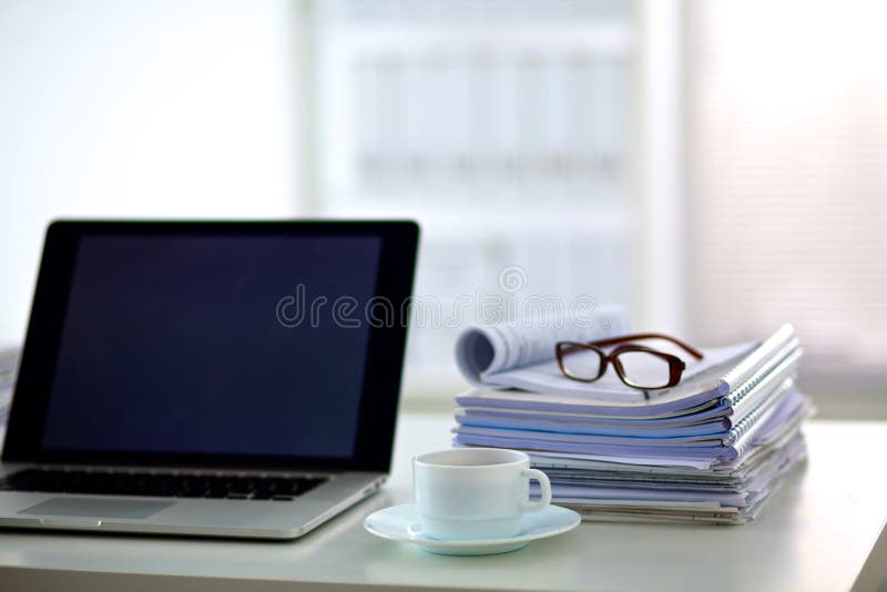 A Stack of Papers on the Desk with a Computer Stock Image - Image of ...