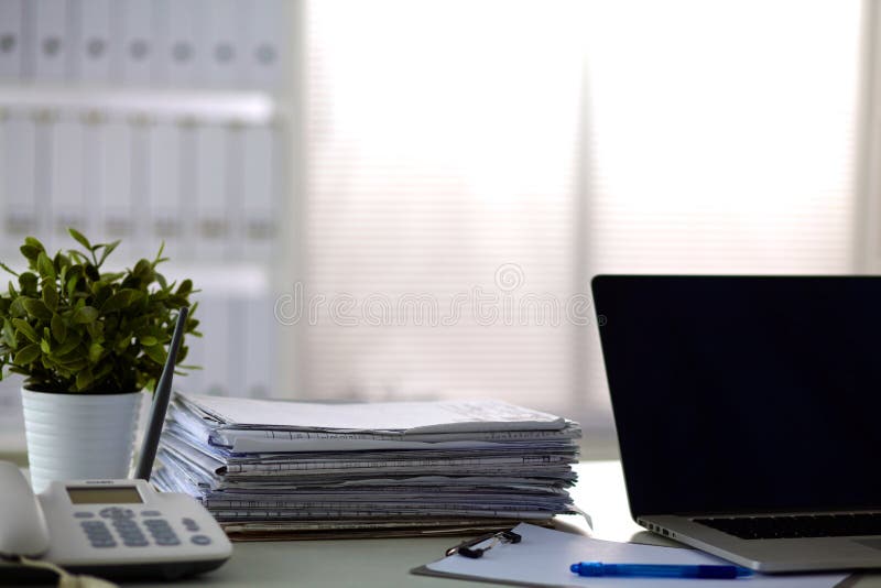 A Stack of Papers on the Desk with a Computer Stock Image - Image of ...