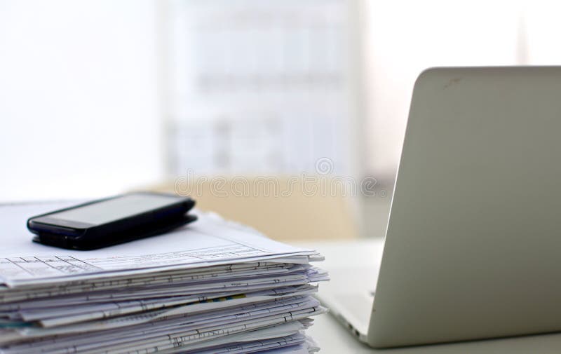 A Stack of Papers on the Desk with a Computer Stock Image - Image of ...