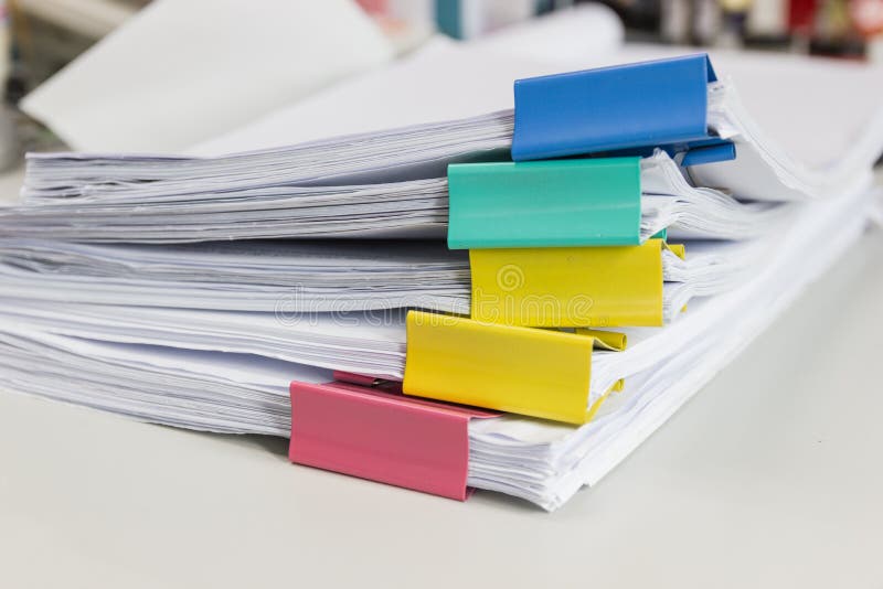 Stack of Papers Documents in Archives Files with Paper Clips on Desk at ...