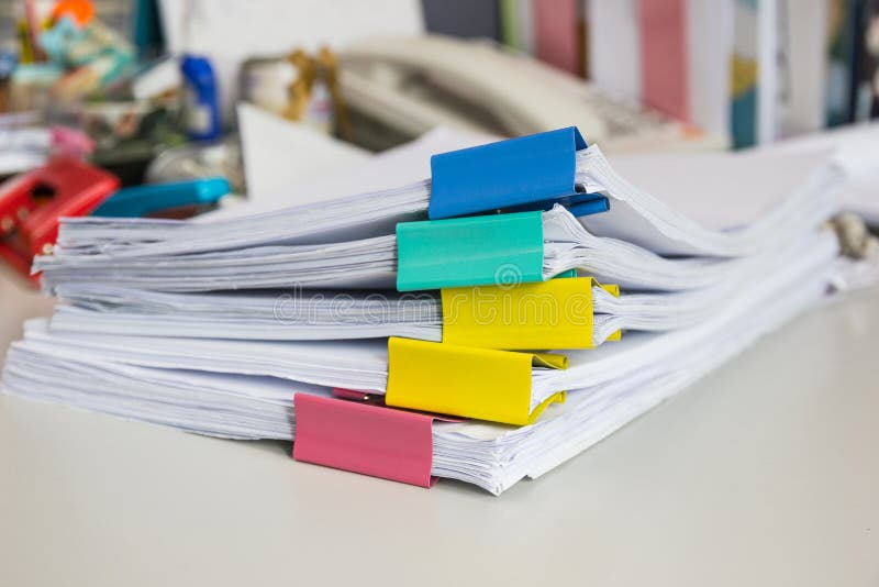 Stack of Papers Documents in Archives Files with Paper Clips on Desk at ...