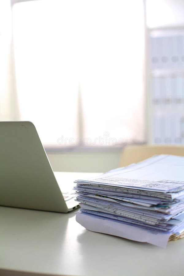 Stack of Papers and Glasses Lying on Table Desaturated Stock Photo ...