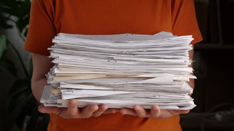 Stack of Paperwork. an Office Worker Holds a Large Stack of Paper in ...