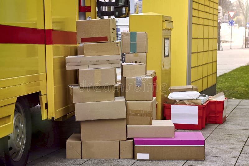 Stack of Parcels Next To a Delivery Van are Standing on the Sidewalk ...