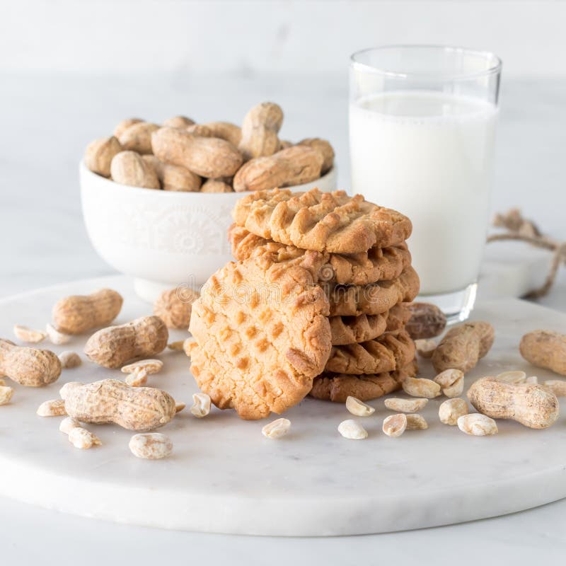 A Stack of Peanut Butter Cookies with a Glass of Milk and Peanuts All ...