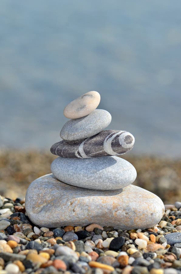 Stack of pebbles on beach stock photo. Image of blue - 86674056