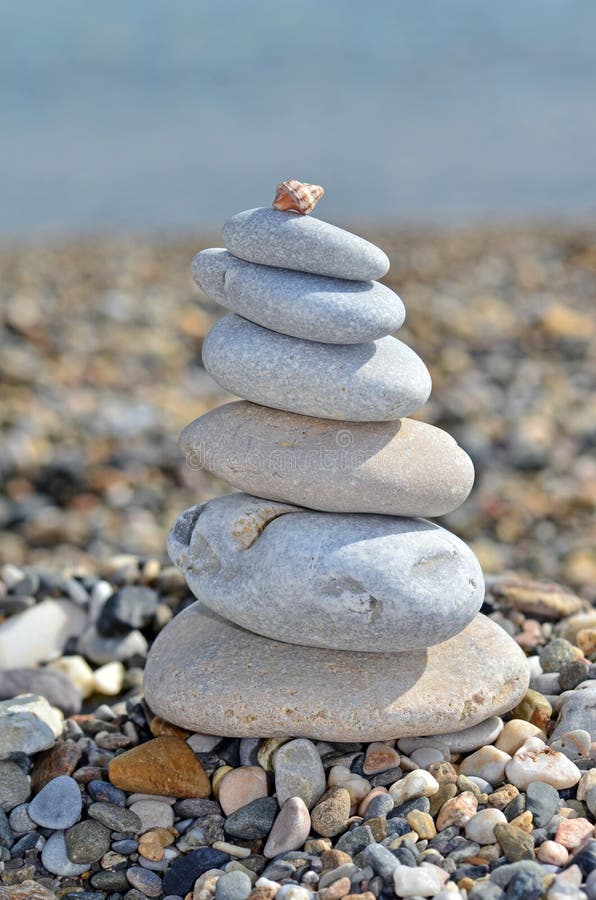 Stack of pebbles on beach stock photo. Image of blue - 86674272