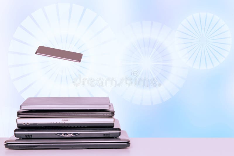 Stack or Pile of Laptop Computers and a Smartphone on a Bright Table ...