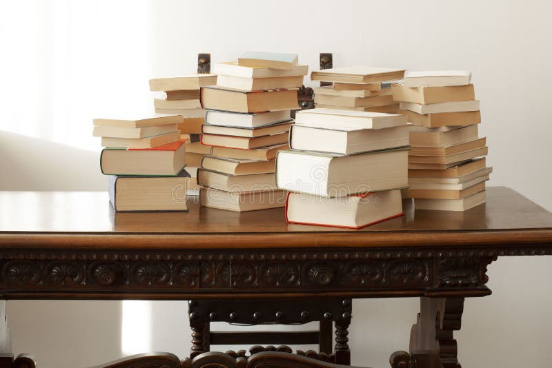 Stack of Piled Books Rest on a Wooden Table with Copy Space for Your ...