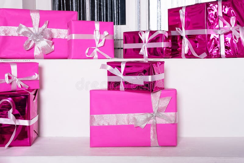 Stack of Pink Celebration Gift Boxes with Ribbon Bows on White Table ...