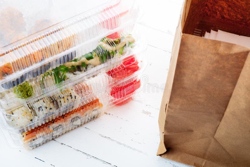 Stack of Plastic Boxes with Sushi Roll Sets and Paper Bag. Stock Image ...