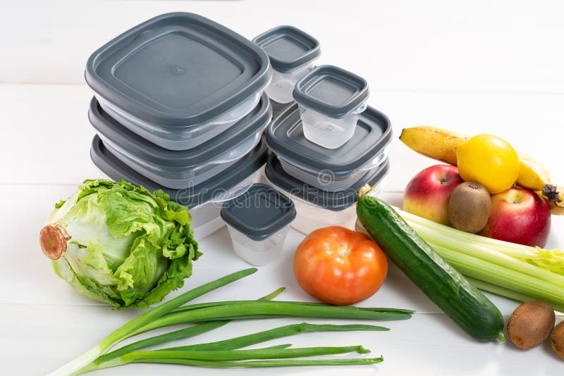 A Stack of Plastic Containers and Raw Vegetables on the Table. Storage ...