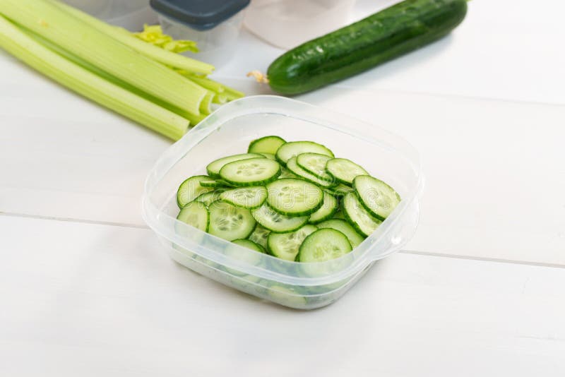 A Stack of Plastic Containers and Raw Vegetables on the Table. Storage ...
