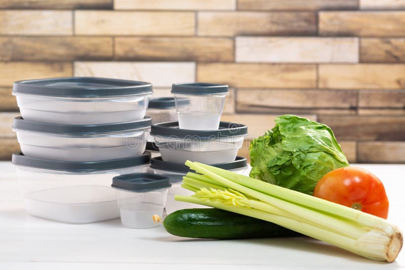 A Stack of Plastic Containers and Raw Vegetables on the Table. Storage ...