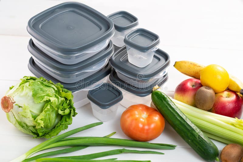 A Stack of Plastic Containers and Raw Vegetables on the Table. Storage ...