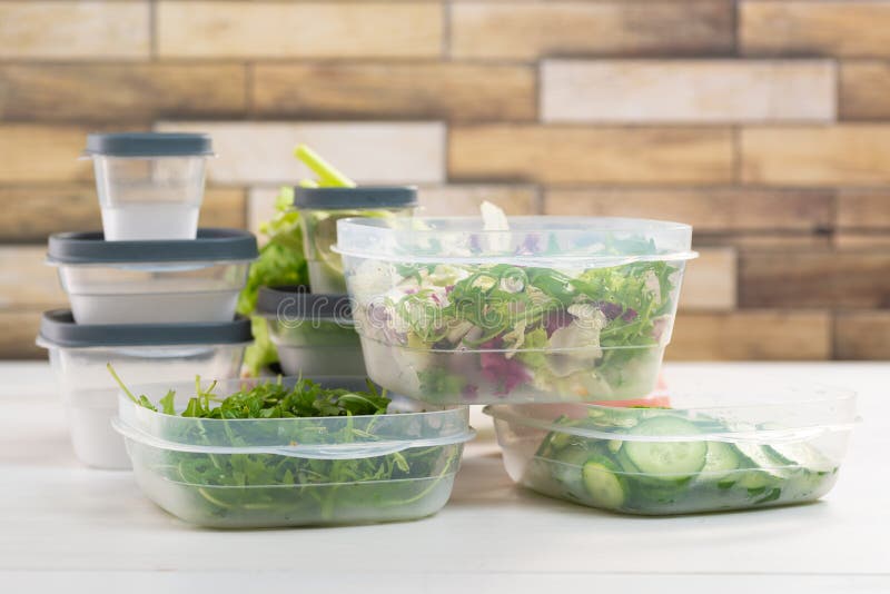 A Stack of Plastic Containers and Raw Vegetables on the Table. Storage ...