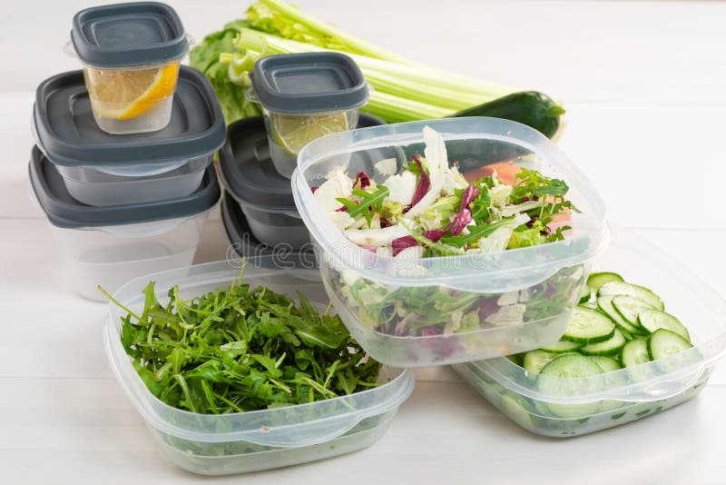 A Stack of Plastic Containers and Raw Vegetables on the Table. Storage ...