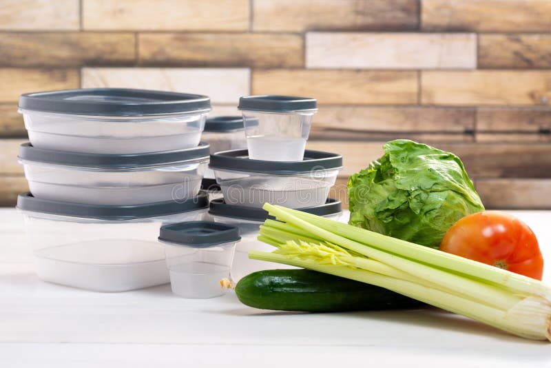 A Stack of Plastic Containers and Raw Vegetables on the Table. Storage ...