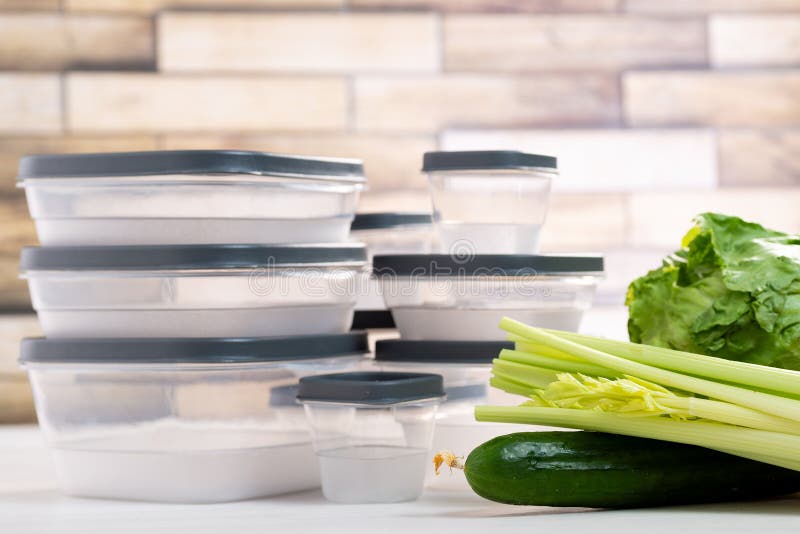 A Stack of Plastic Containers and Raw Vegetables on the Table. Storage ...