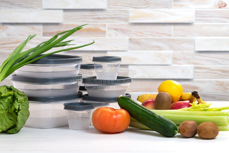 A Stack of Plastic Containers and Raw Vegetables on the Table. Storage ...