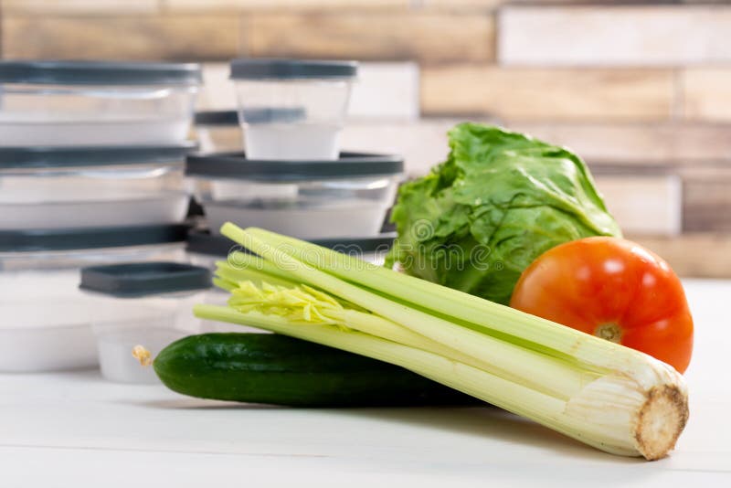 A Stack of Plastic Containers and Raw Vegetables on the Table. Storage ...