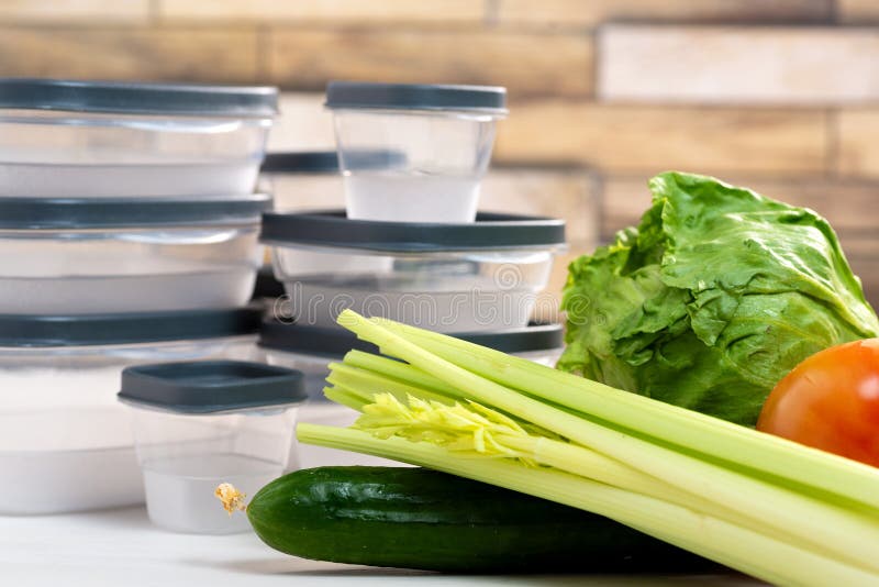 A Stack of Plastic Containers and Raw Vegetables on the Table. Storage ...