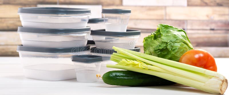 A Stack of Plastic Containers and Raw Vegetables on the Table. Storage ...