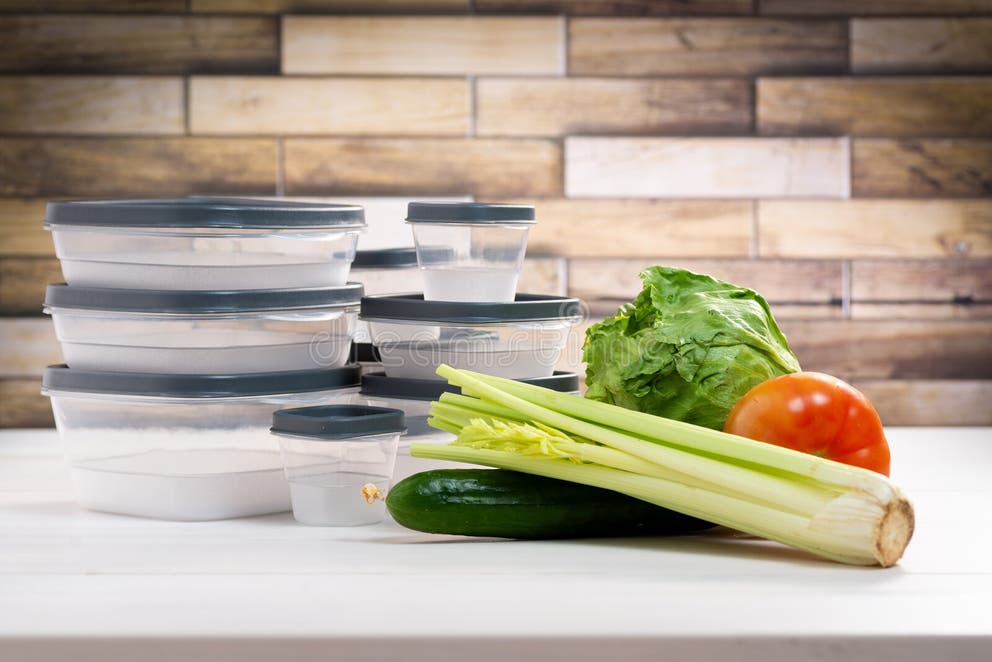 A Stack of Plastic Containers and Raw Vegetables on the Table. Storage ...