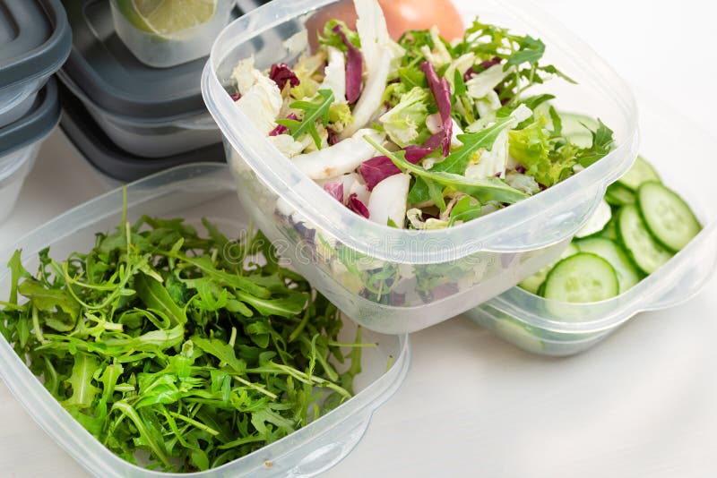 A Stack of Plastic Containers and Raw Vegetables on the Table. Storage ...
