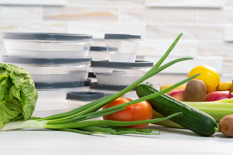 A Stack of Plastic Containers and Raw Vegetables on the Table. Storage ...