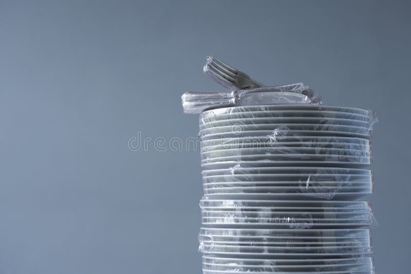 Stack of Plates and Cutlery Wrapped in Plastic Stock Photo - Image of ...