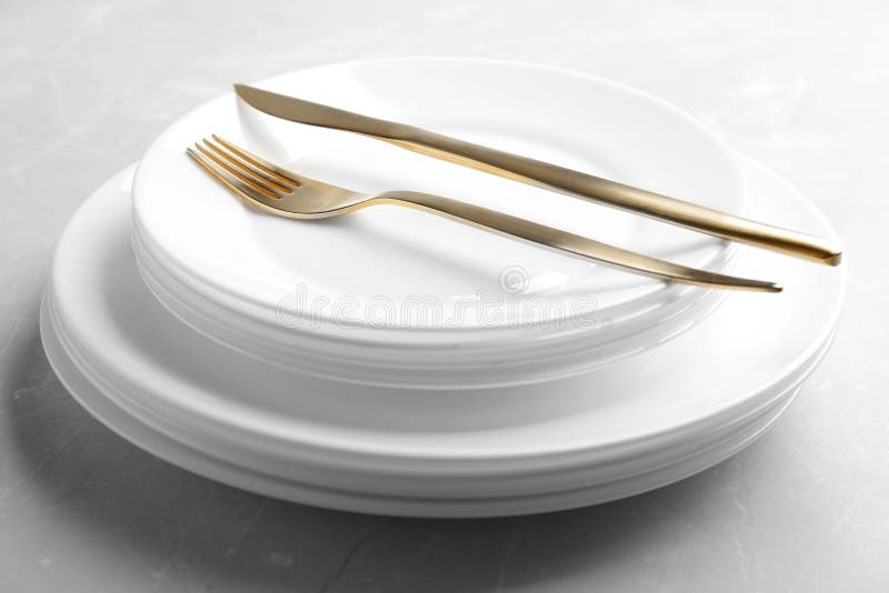 Stack of Plates with Fork and Knife Stock Image - Image of cookware ...