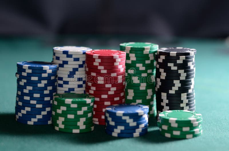 Stack of Poker Chips on a Green Table Stock Image - Image of gambling ...