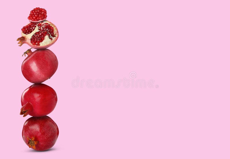Stack of Pomegranate Fruits on Pink Background, Space for Text Stock ...