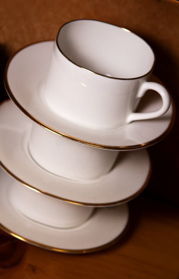 Stack of Porcelain Coffee Cups with Gold Rim on Wooden Background Stock ...