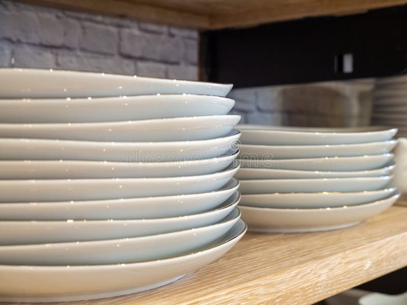 Stack of Porcelain Plates Stacked in Two Piles on Kitchen Shelf Stock ...