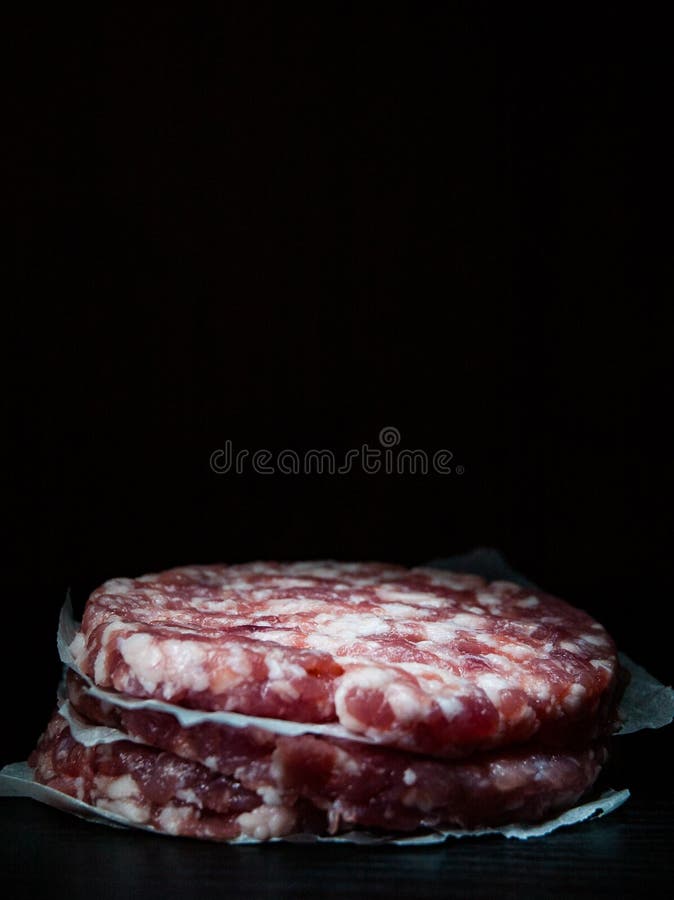 Stack of Raw Beef Meat Burger Steak Cutlets Beefsteack on Paper on Dark ...