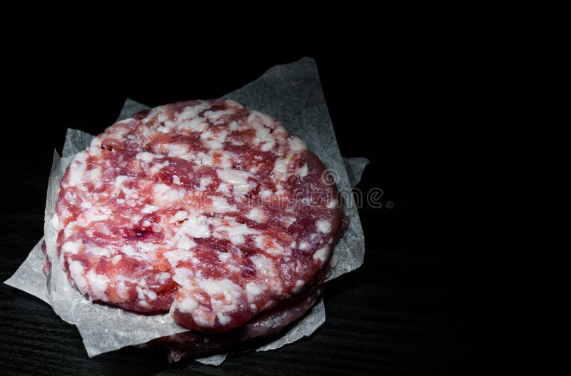 Stack of Raw Beef Meat Burger Steak Cutlets Beefsteack on Paper on Dark ...