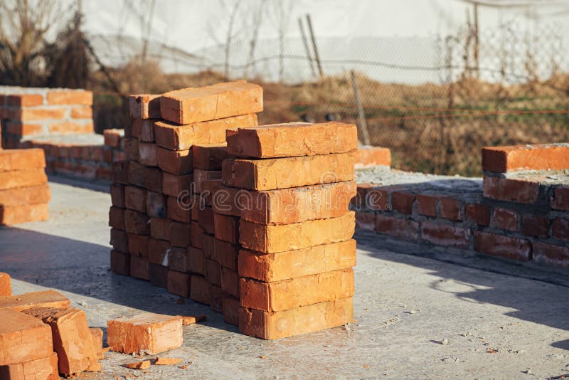 Stack of Red Bricks on Concrete Foundation, Process of House Building ...