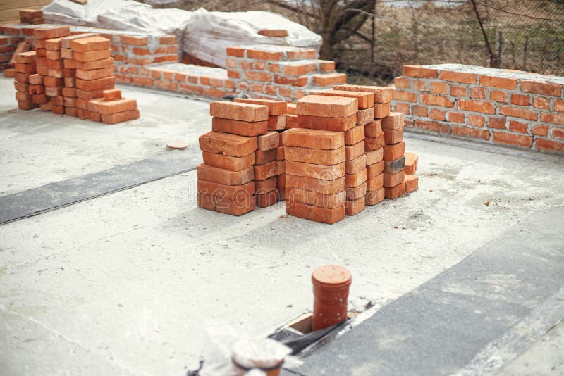 Stack of Red Bricks on Concrete Foundation, Process of House Building ...
