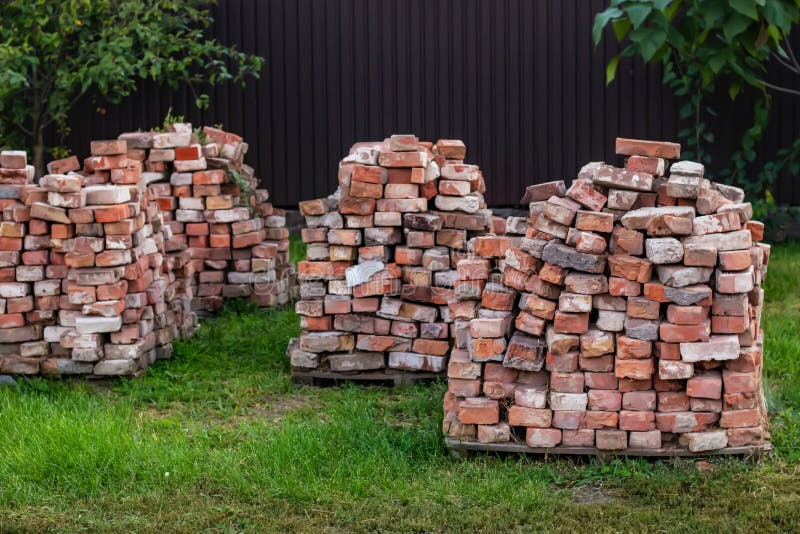A Stack of Red Clay Bricks on a Grass Stock Photo - Image of bricks ...